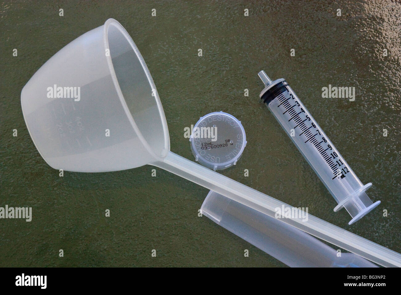 A Veterinary Urine collection kit on a glass table Stock Photo - Alamy