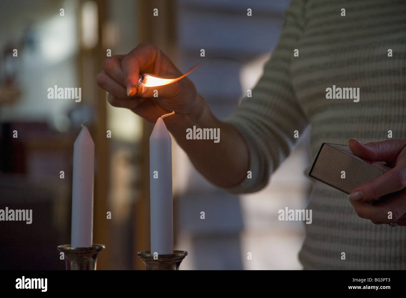 Woman lighting candle back view hi-res stock photography and images - Alamy