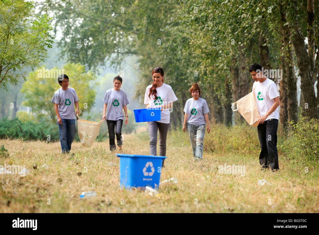 young people collecting empty plastic bottles for recycling Stock Photo ...