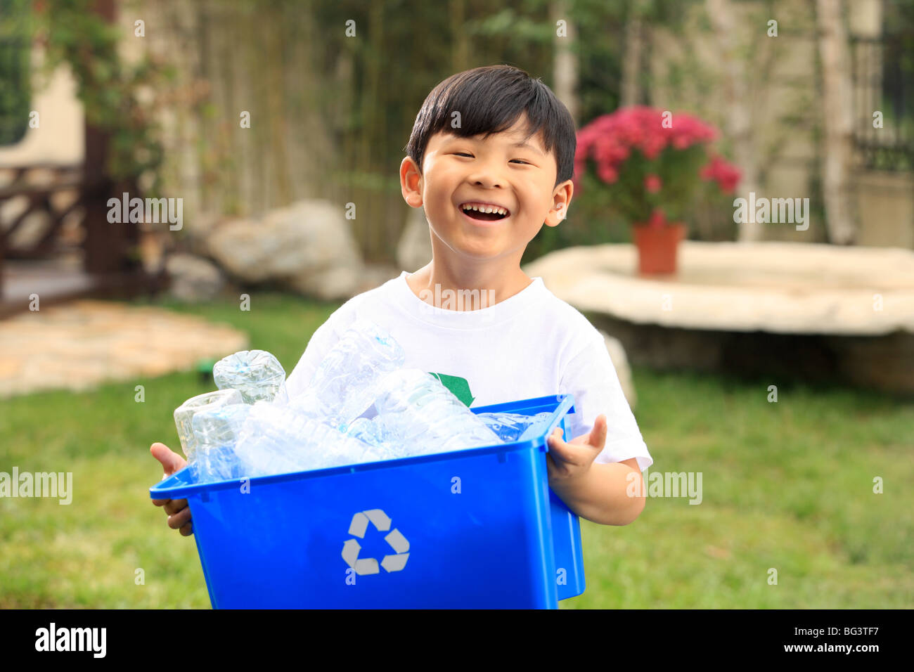 boy holding recycling container with empty plastic bottles inside Stock ...