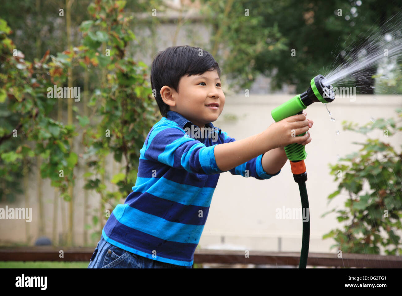 Children watering tree hi-res stock photography and images - Alamy