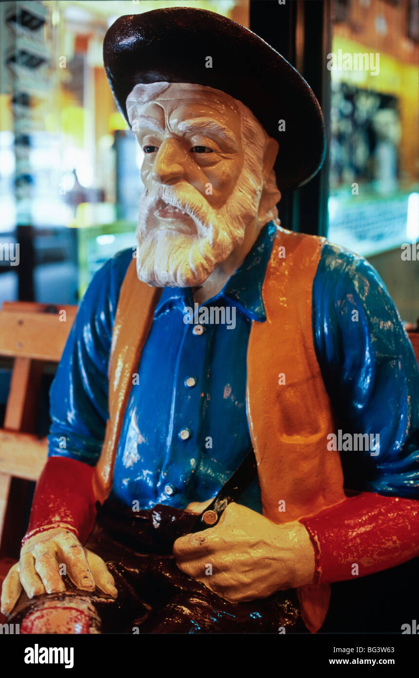 Lifesize cowboy figure sitting on a bench in Wall Drug Store, well ...