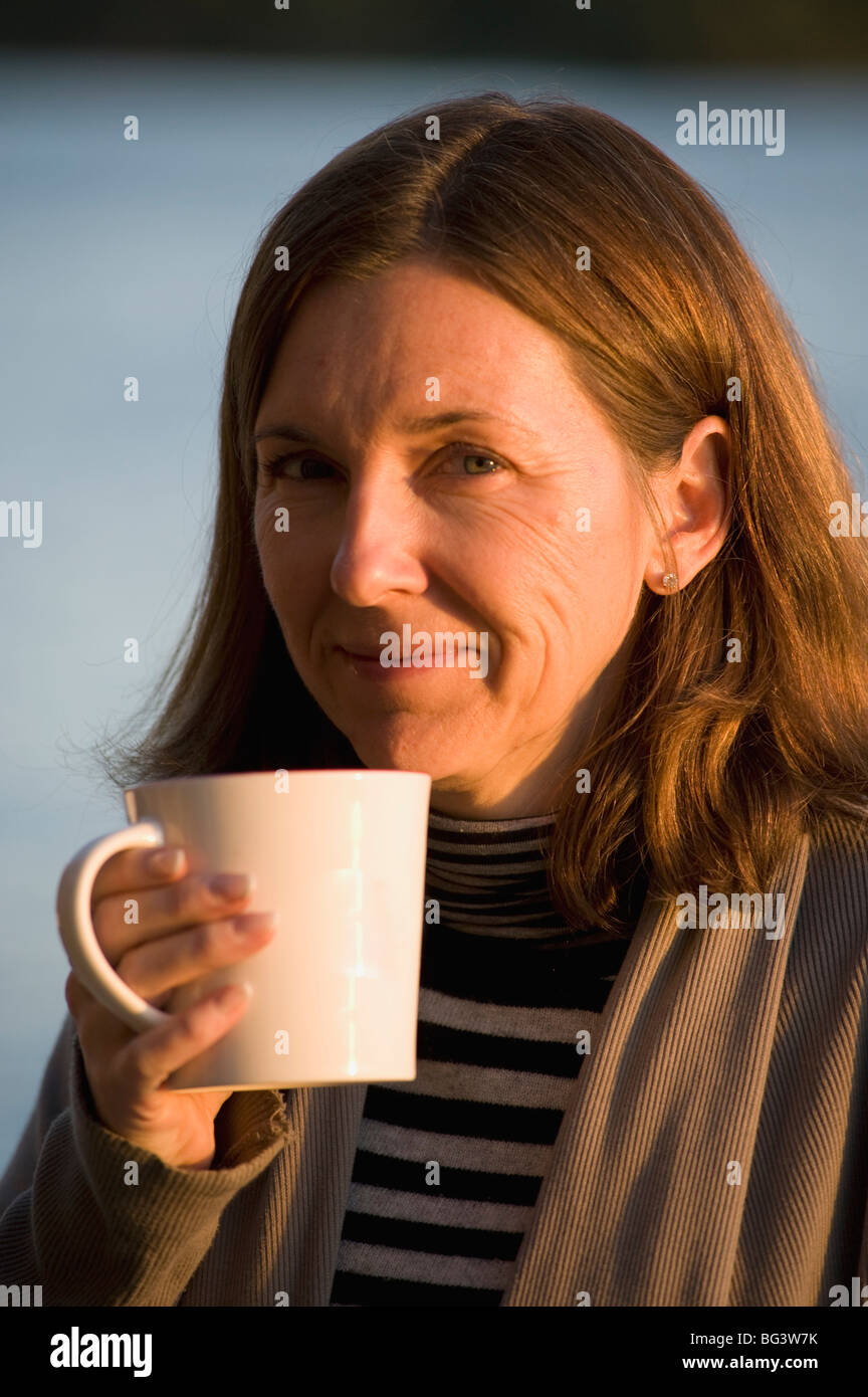 Woman enjoying her morning coffee Stock Photo - Alamy