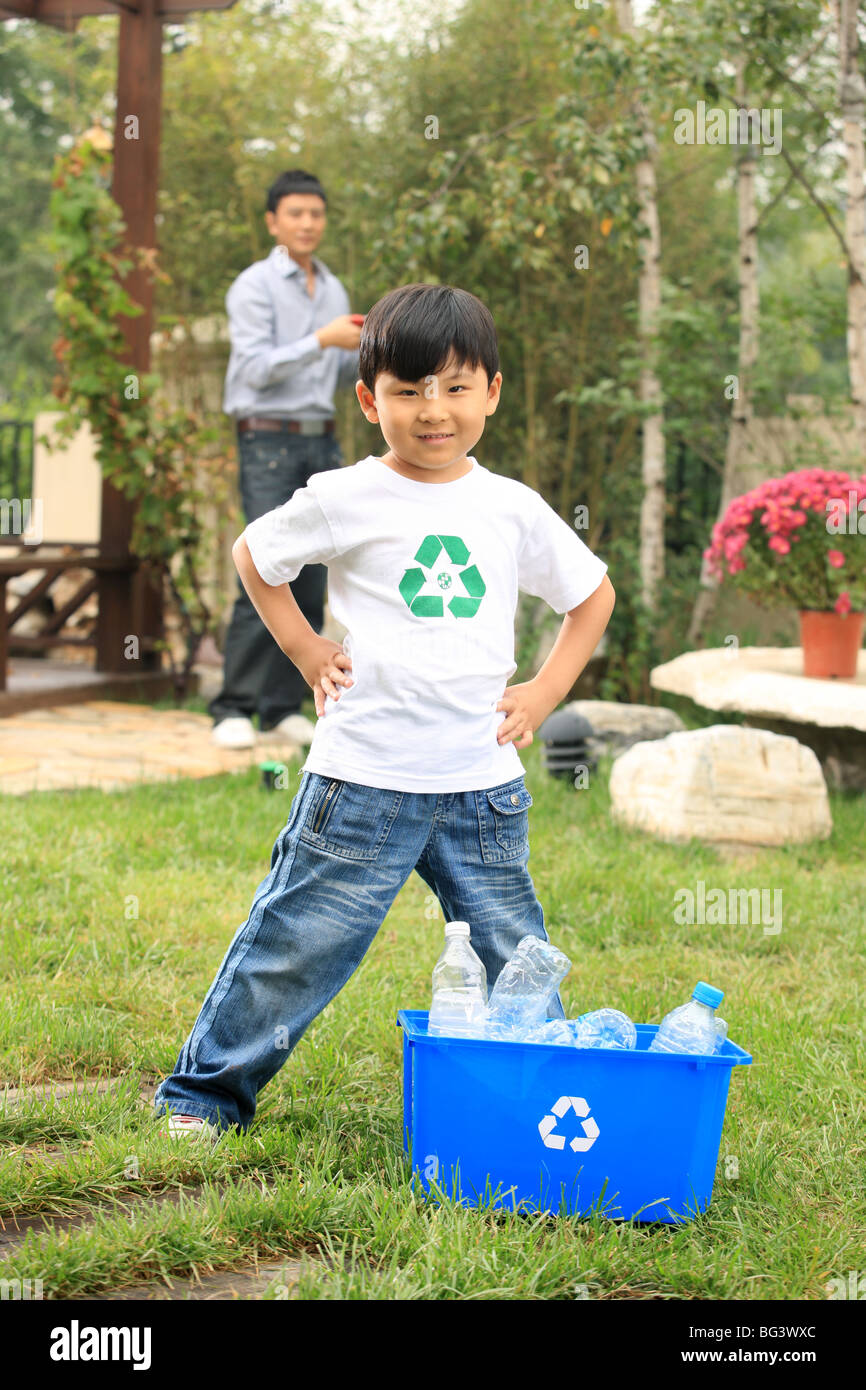 boy with recycling container with empty plastic bottles inside Stock ...