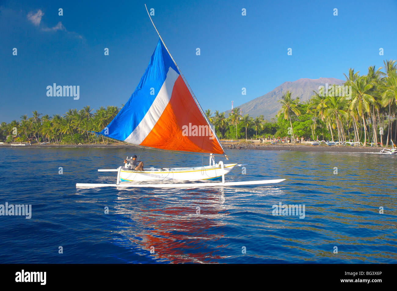 Local fisherman on a traditional outrigger boat, Bali, Indonesia ...