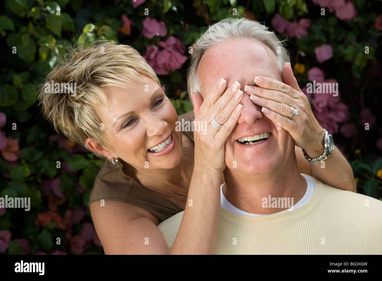 Middle-aged having fun in garden Stock Photo - Alamy