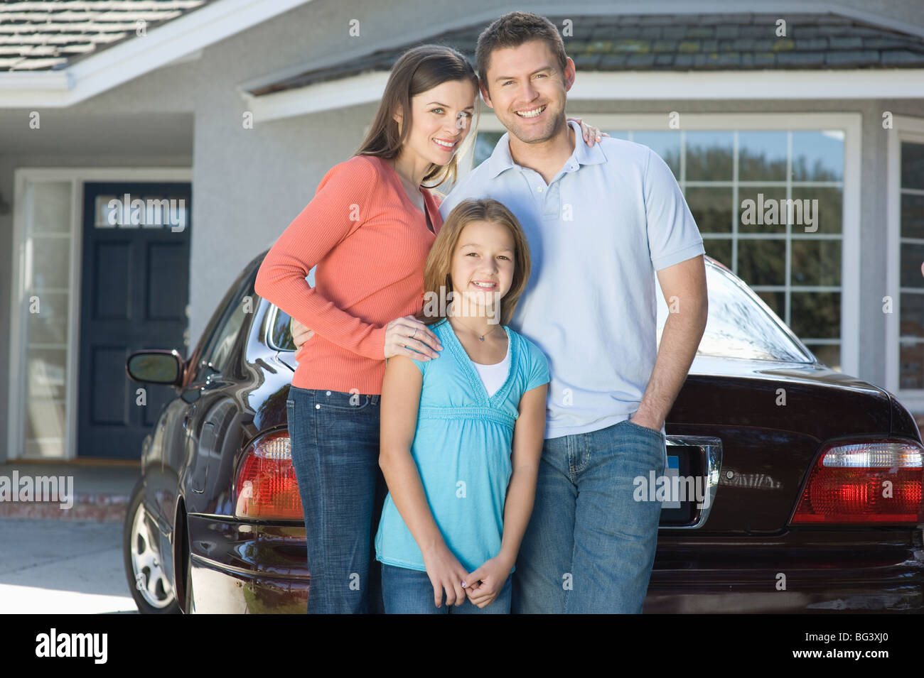 Family outside house with car Stock Photo - Alamy