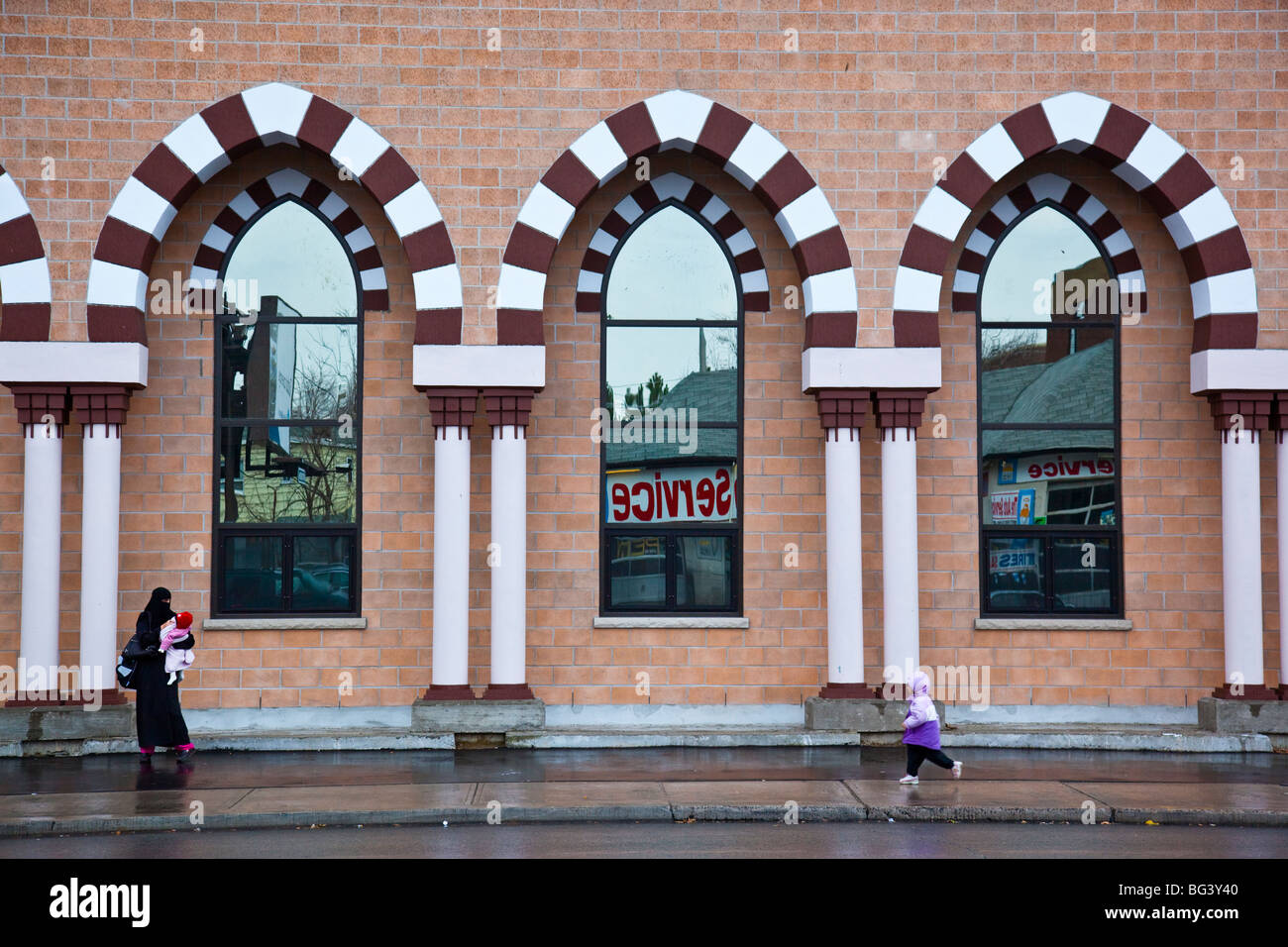 Muslim mother and children in front of Madina Masjid in Toronto Canada ...