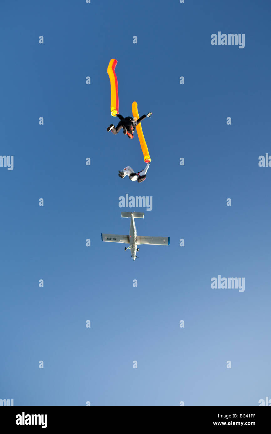Skydivers with colorful tubes exit out of the plane. The Freeflyers are ...