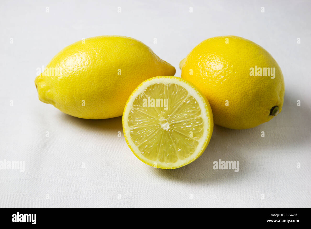 Two Lemons and Half a Lemon on a White Background Stock Photo - Alamy
