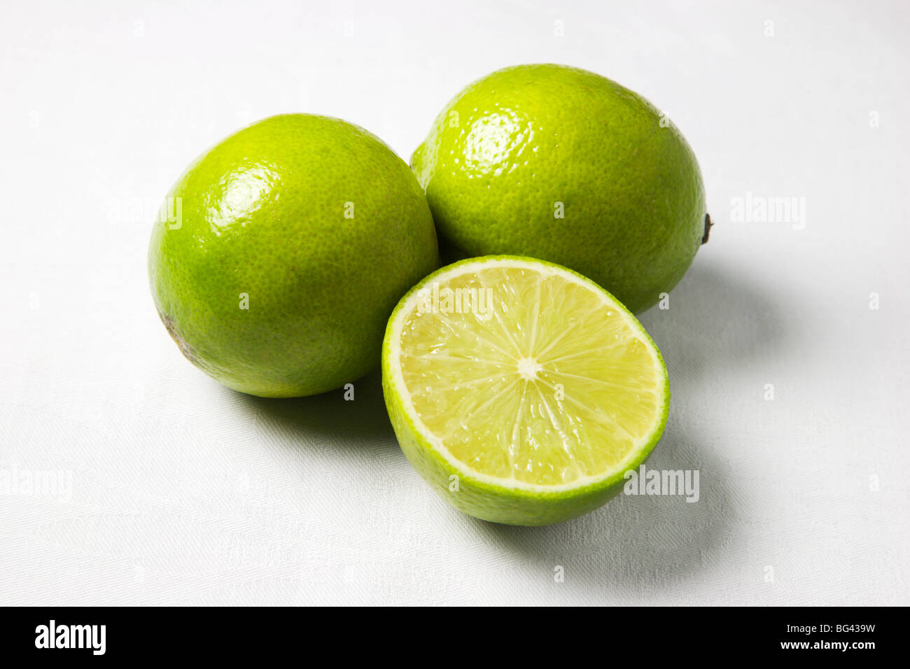 Two Limes a Half a Lime on a White Background Stock Photo - Alamy
