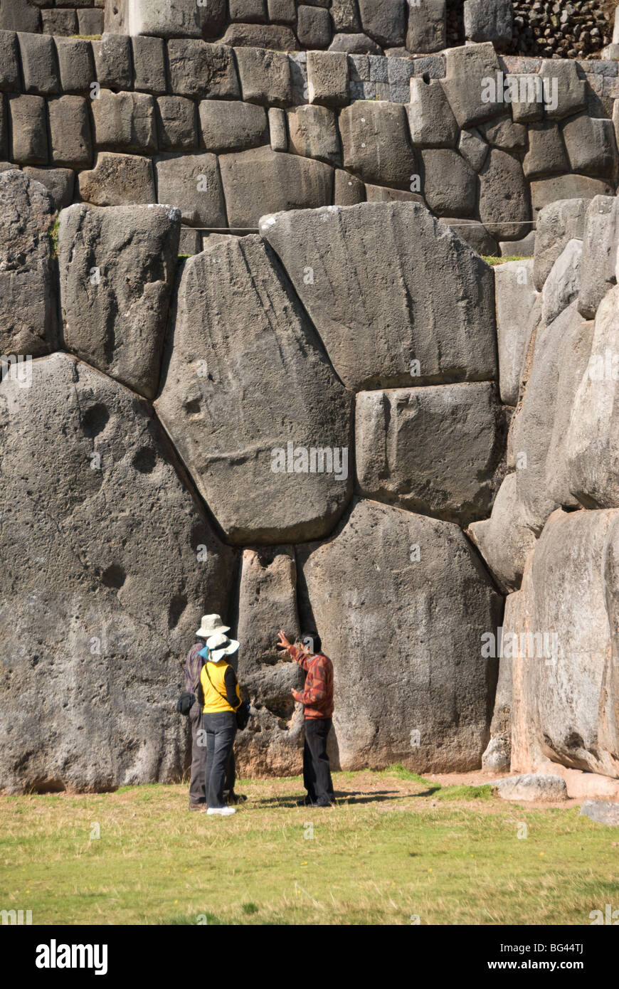 Guide talking to tourists at the Inca fortification of Sacsayhuaman ...