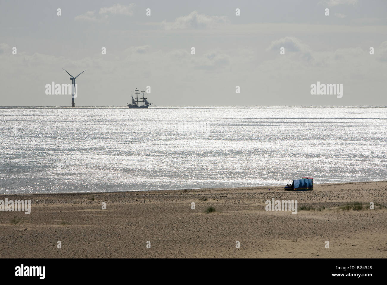 Distant sailing ship off Caister beach near Great Yarmouth Stock Photo ...