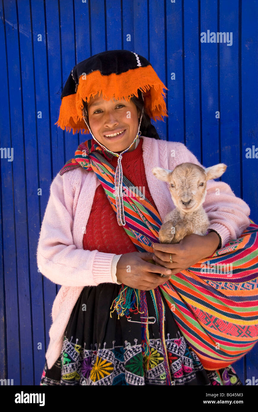 Inca woman in traditional dress with small lamb, Pisac, Sacred Valley ...