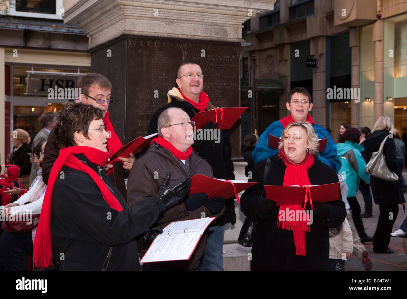 UK, England, Manchester, St Annes Square choir members carol singing to ...