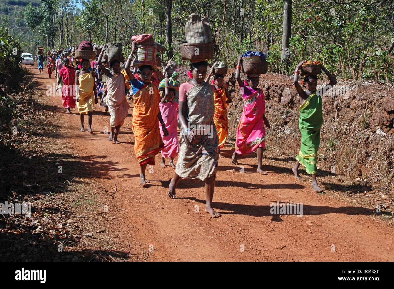 Group of Didai tribeswomen walking from their village to the local ...