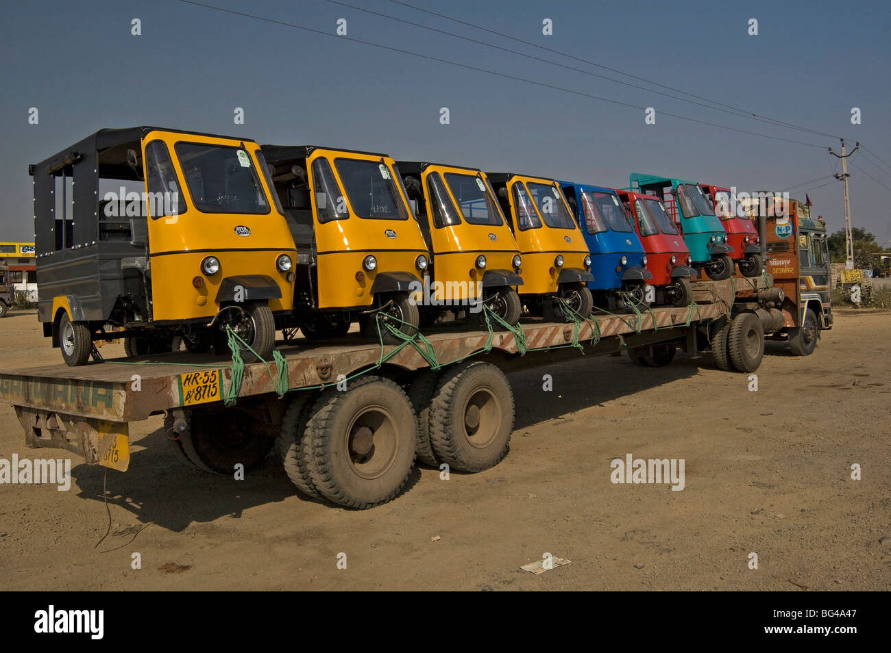 New tuc tuc rickshaws being transported from the factory to the city ...