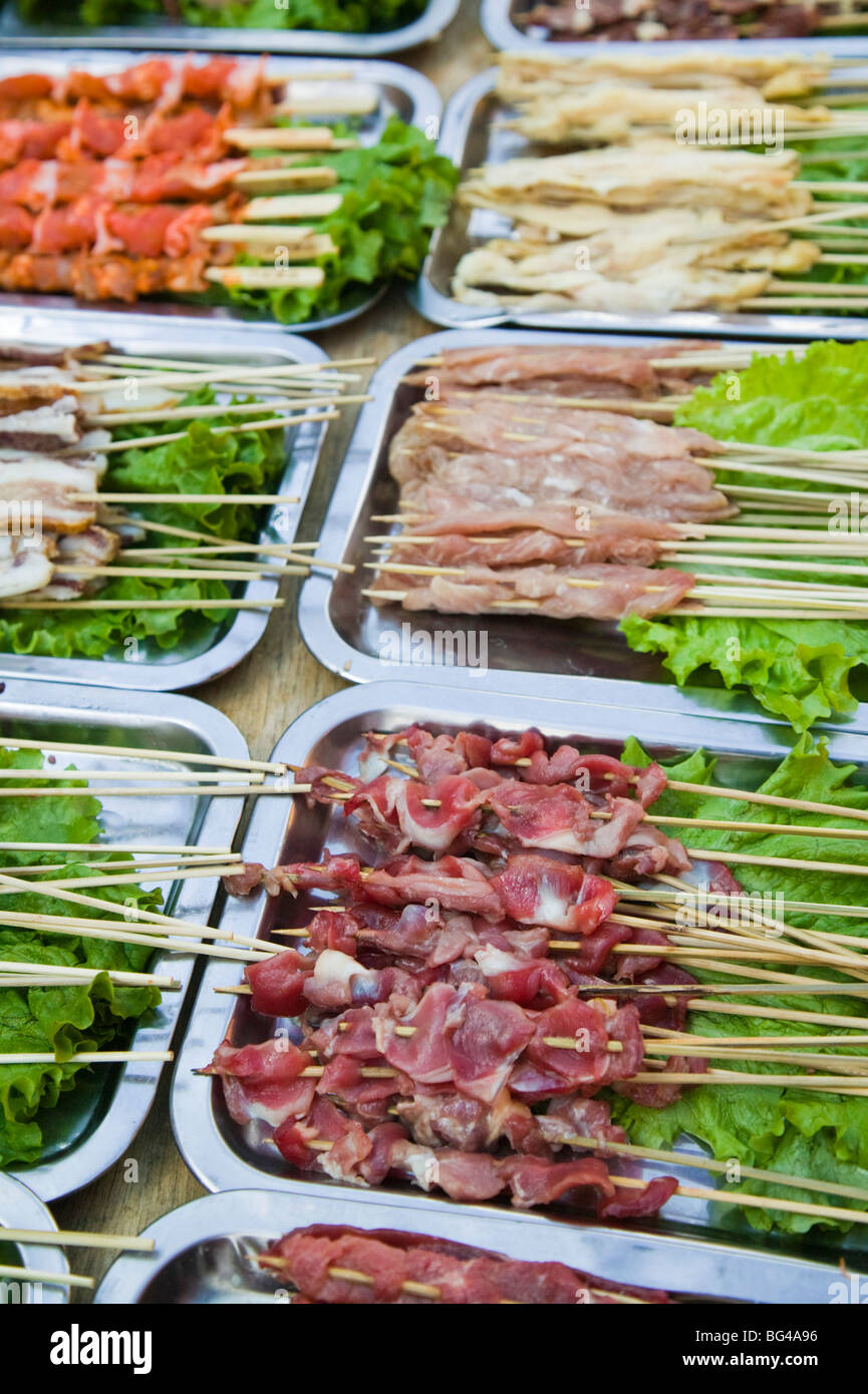 China, Yunnan Province, Lijiang, Old Town, Snacks at outdoor grill ...