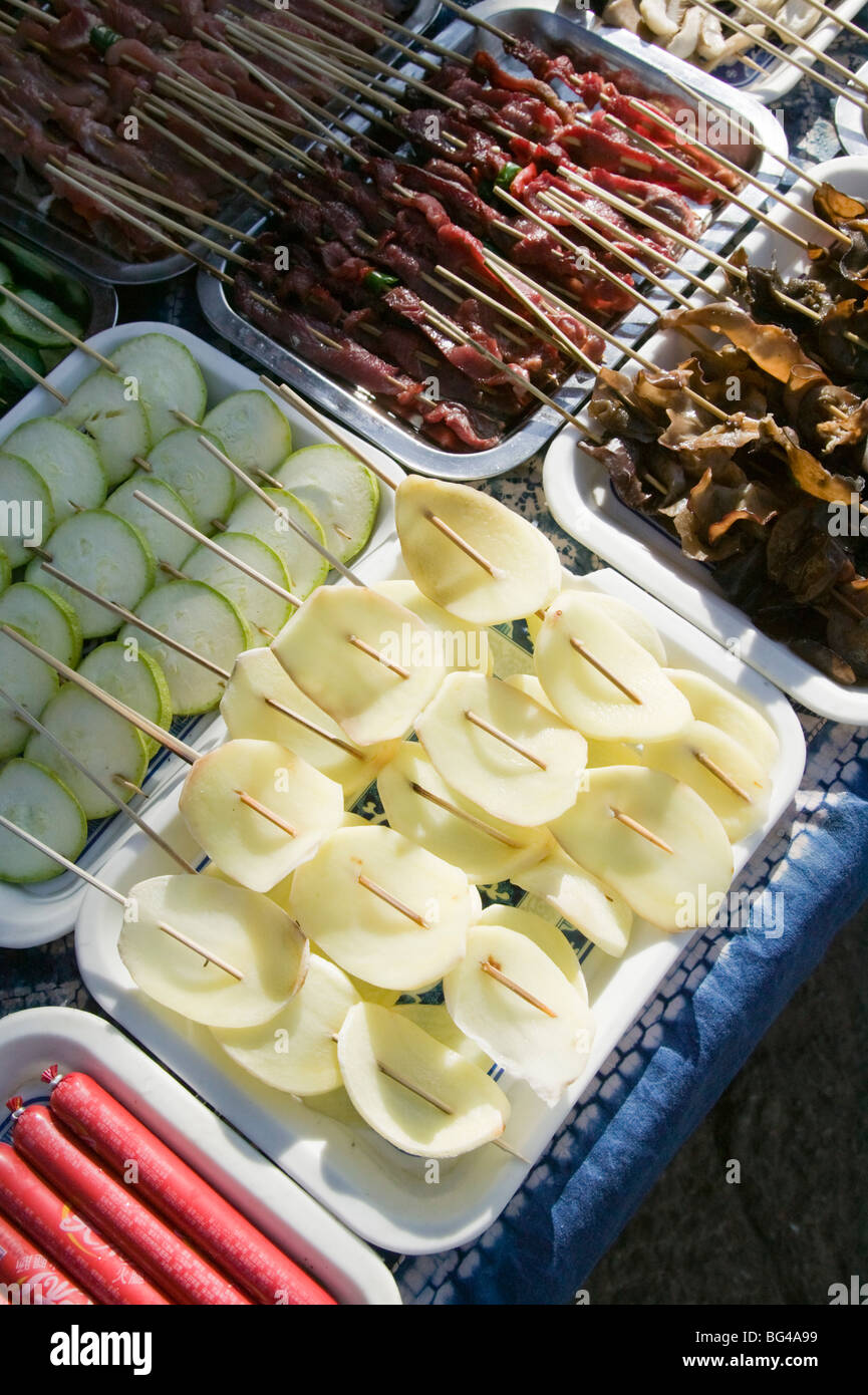 China, Yunnan Province, Lijiang, Old Town, Snacks at outdoor grill ...