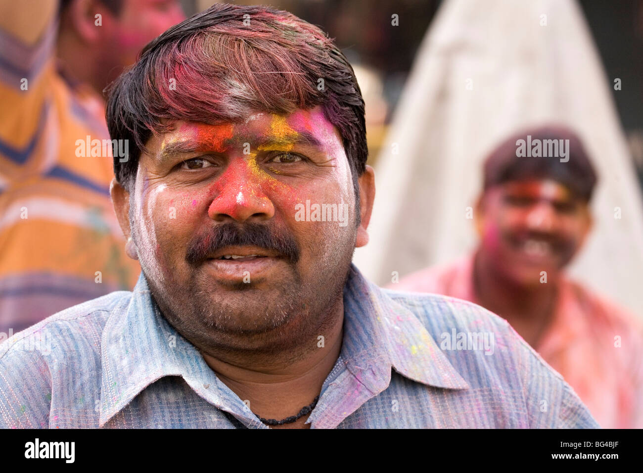 An Indian man enjoys Holi in the Paharganj area of Delhi. Holi is often ...