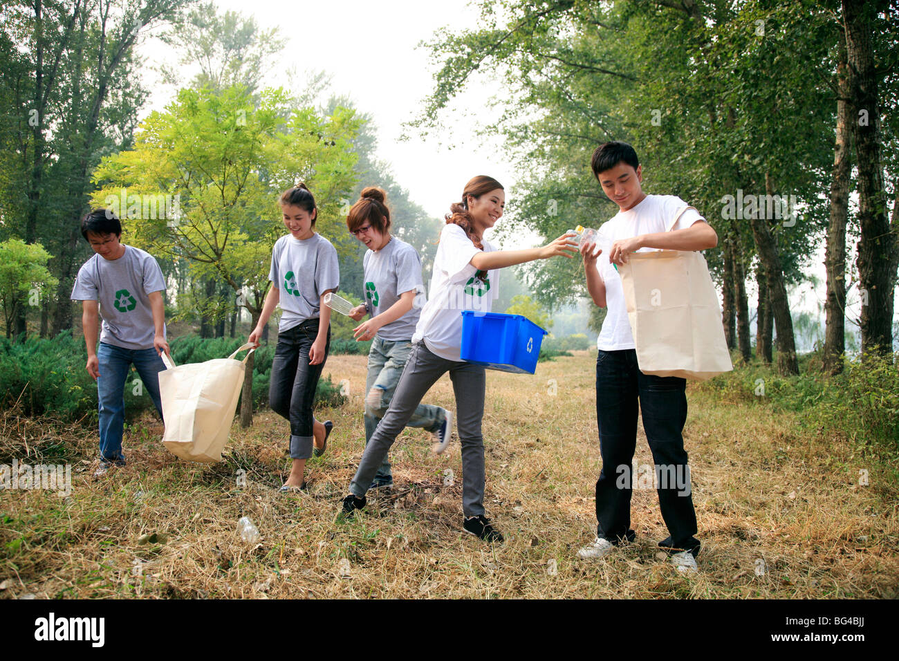 young people collecting empty plastic bottles for recycling Stock Photo ...