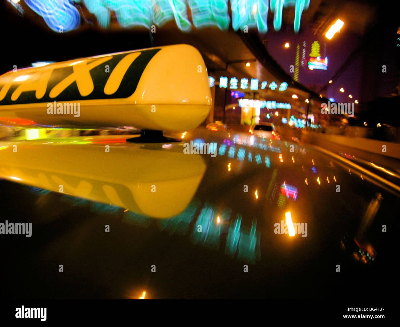 Close up of Taxi sign on car roof with neon road signs, Shanghai, China ...