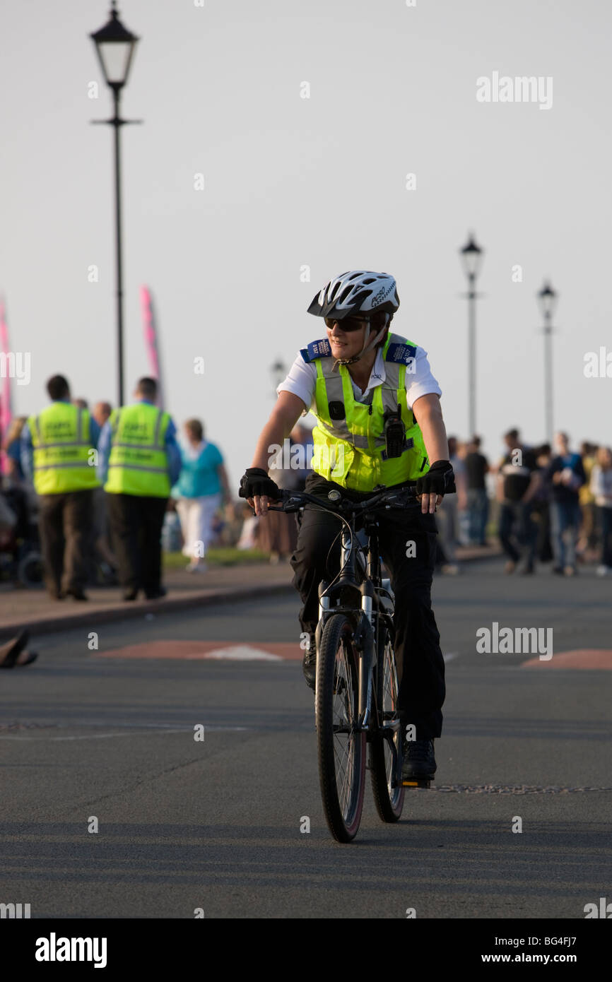 Female police officer on duty riding bicycle Stock Photo - Alamy