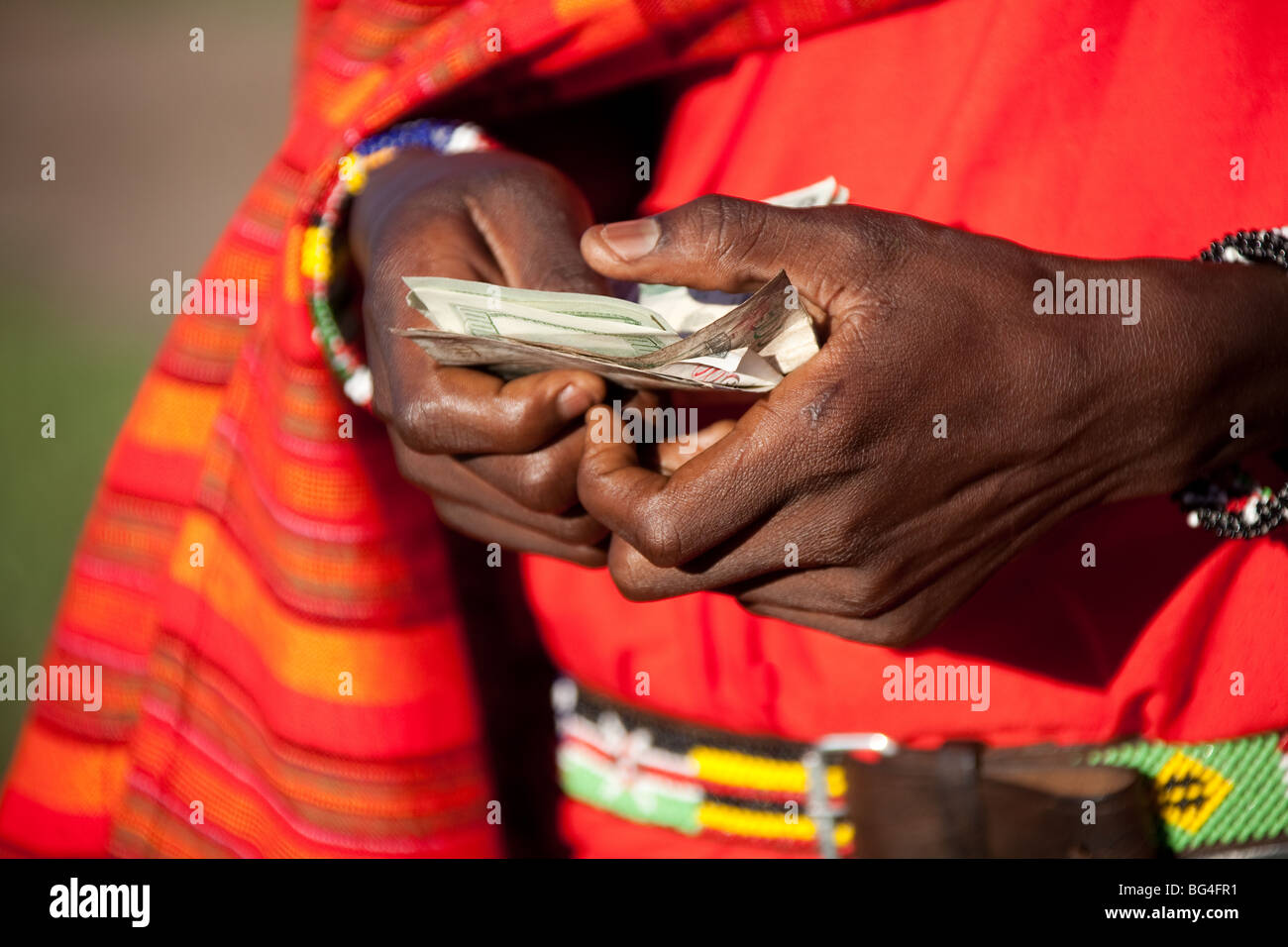 Money in hands of African man Stock Photo - Alamy