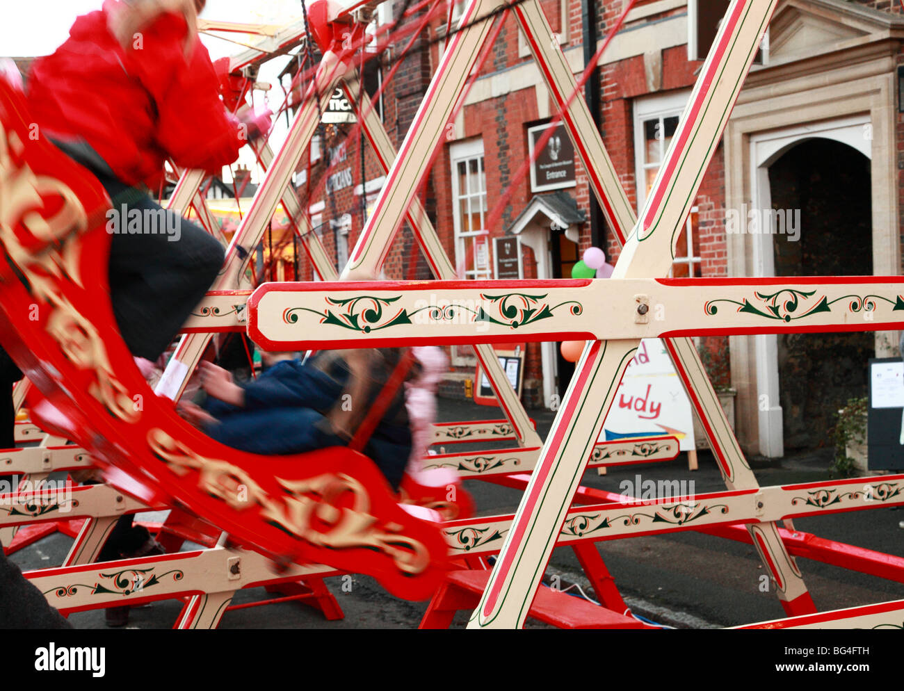 Colourful or colorful traditional swing boats at a Victorian themed ...