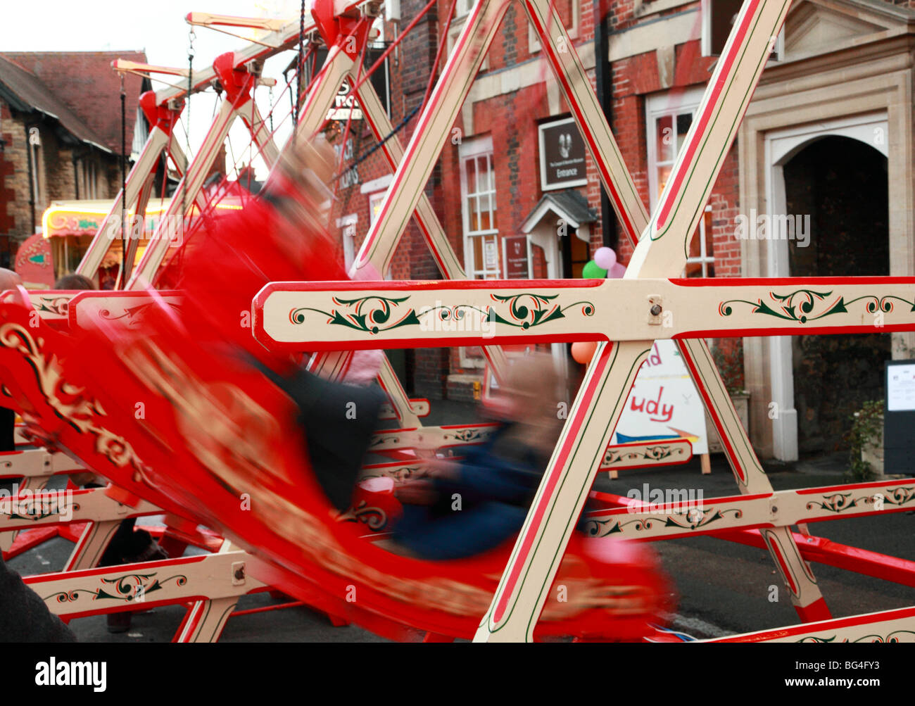 Colourful or colorful traditional swing boats at a Victorian themed ...