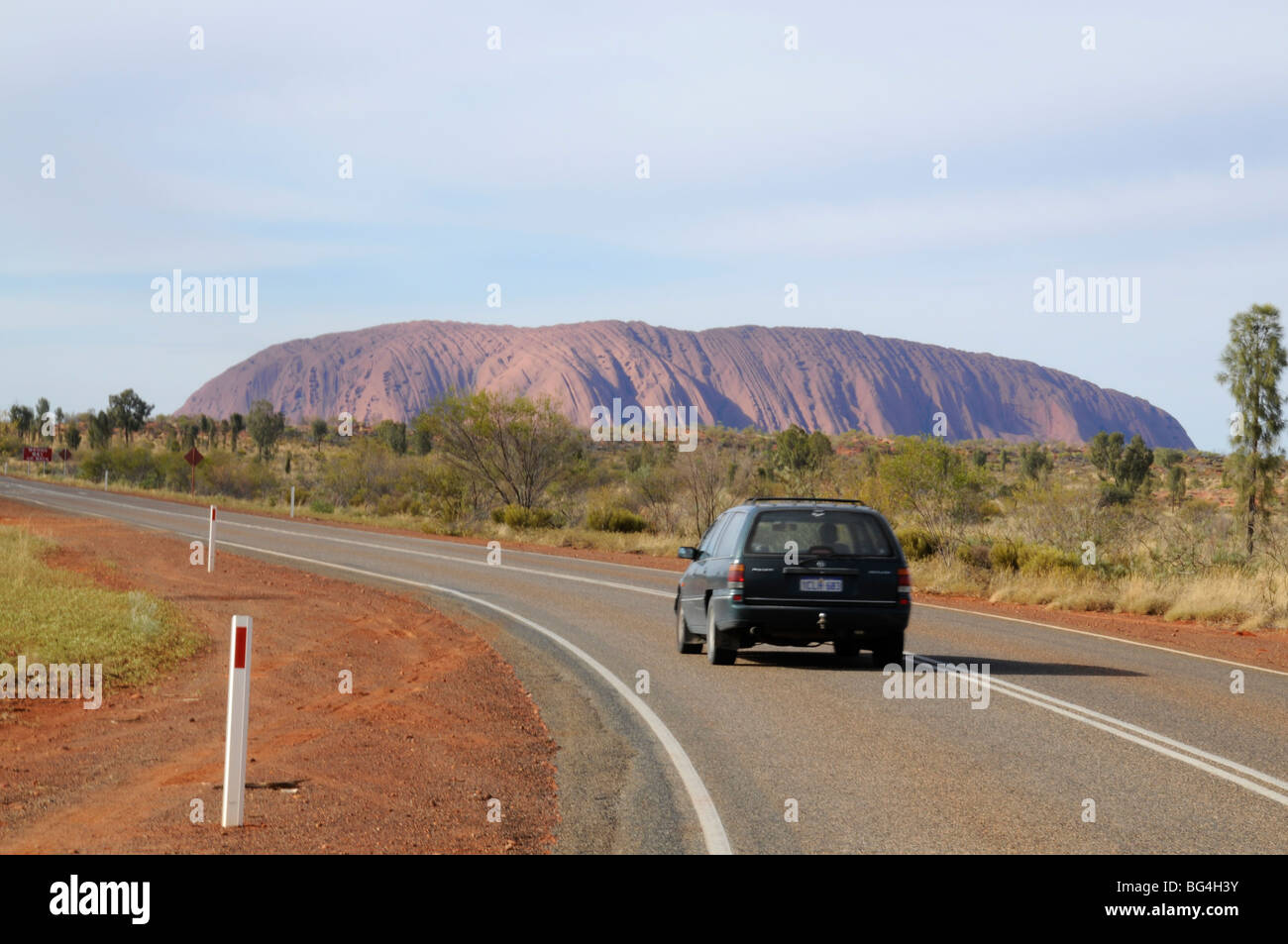 A visitor's car heading towards Uluru, (Ares Rock) in the Uluru-Kata ...