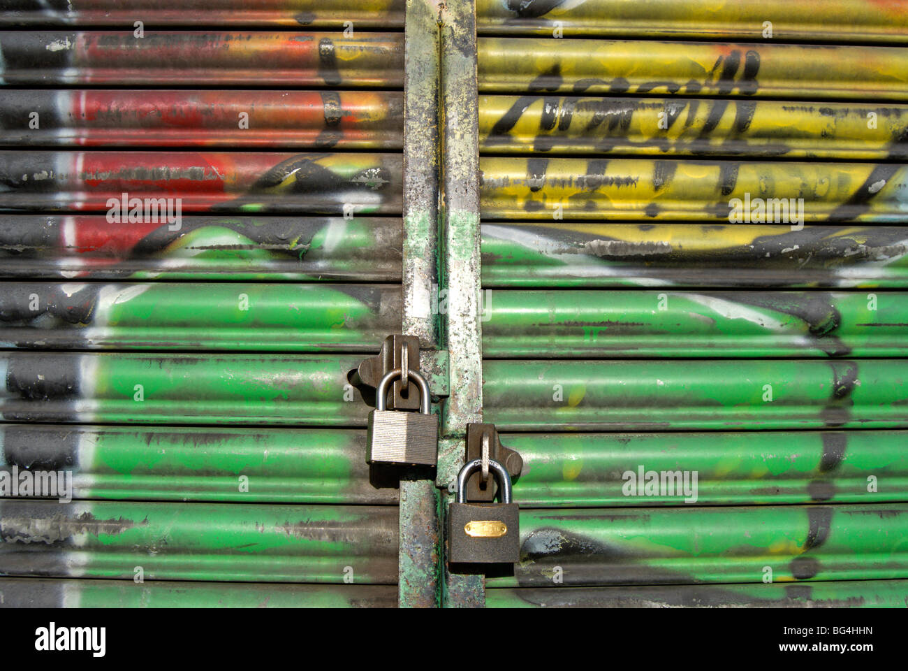 padlocks on graffiti covered shop shutters, in goldhawk road, shepherds ...