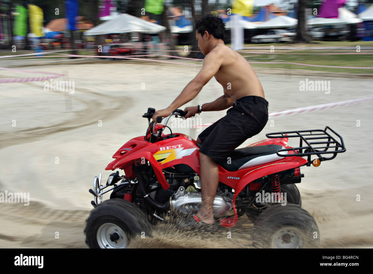 A shirtless rider handling an ATV Stock Photo - Alamy