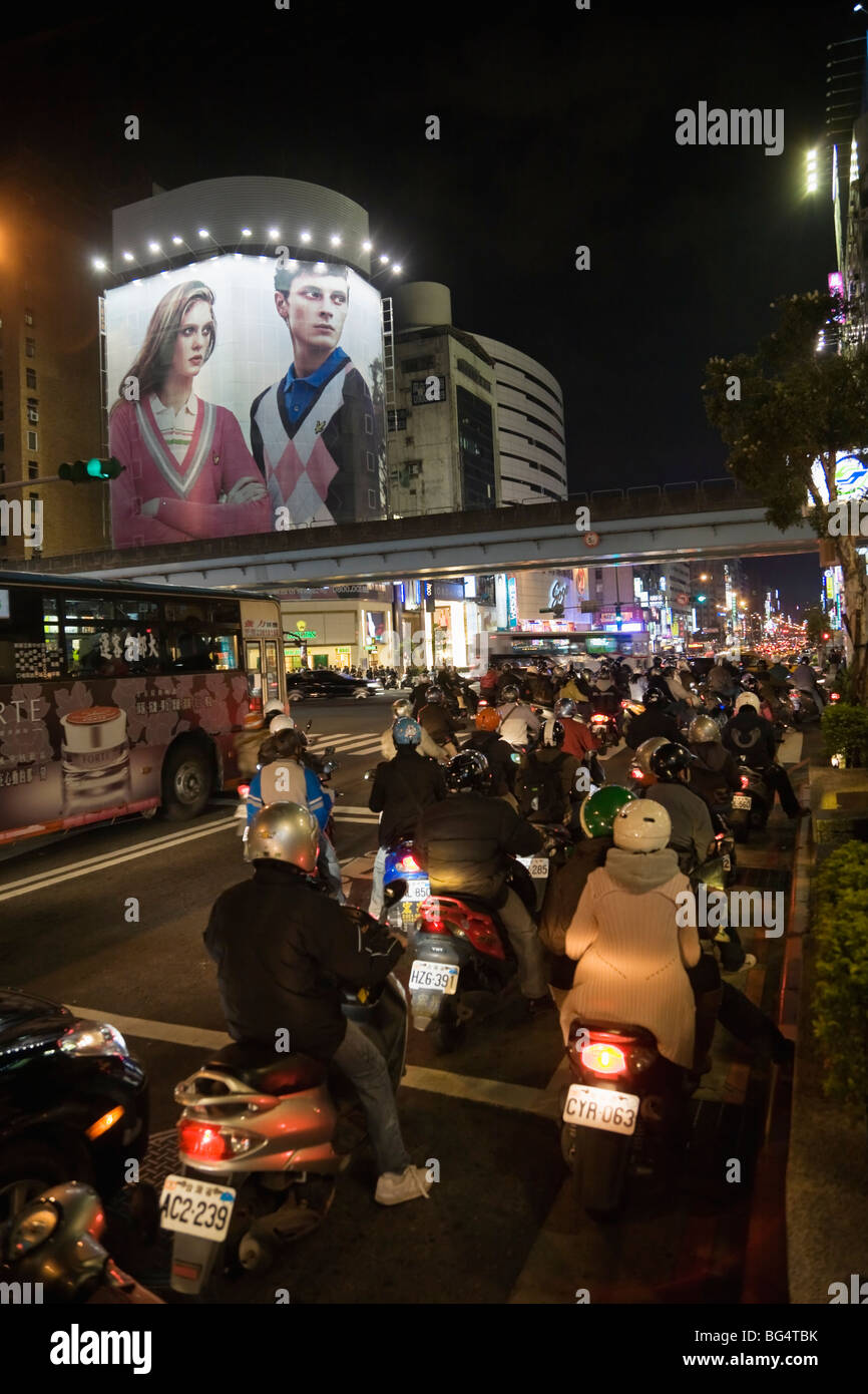 Motorbikes queue up at a red light on Zhongxiao Rd at the intersection ...