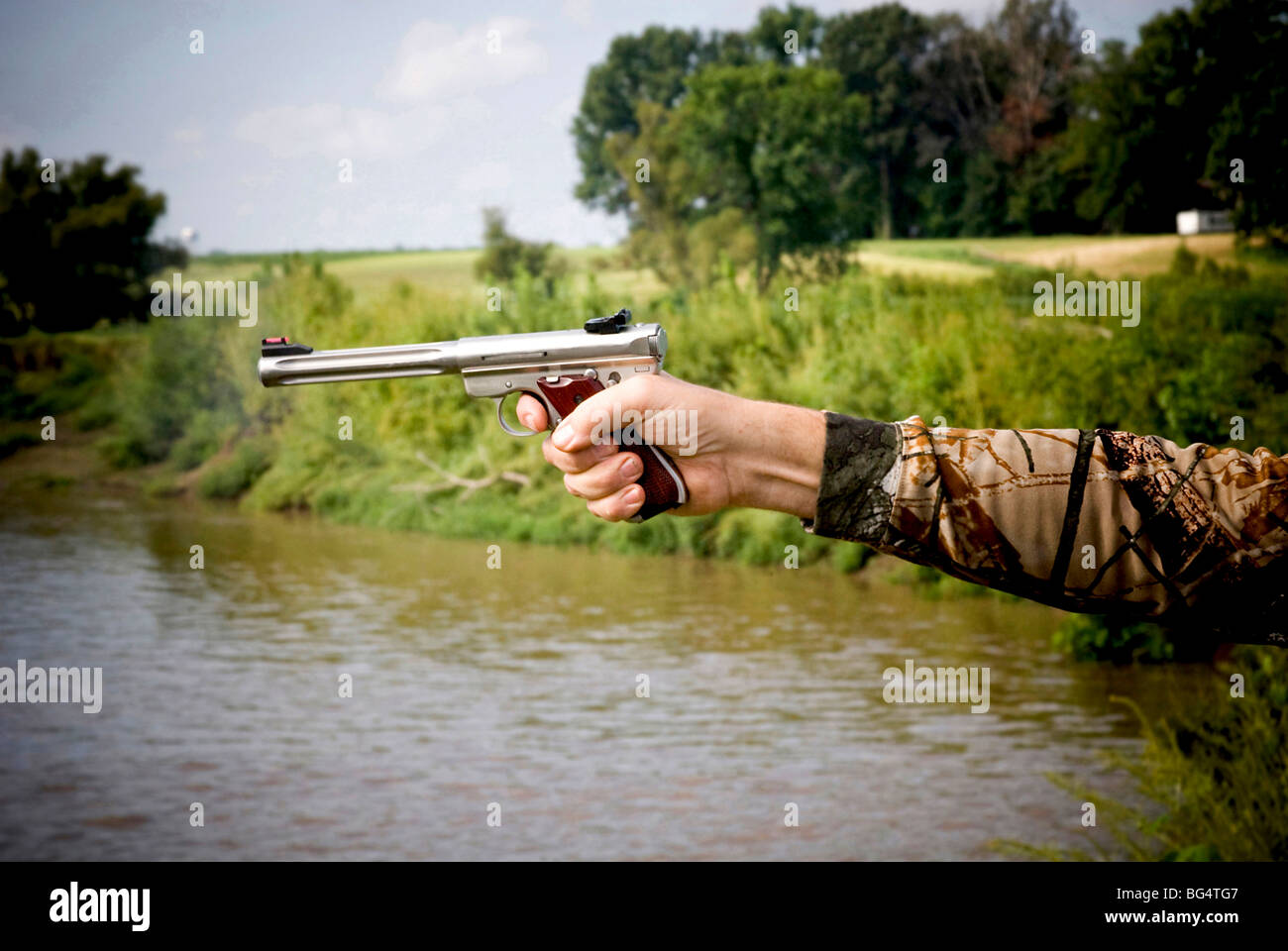 Ready, Aim, Fire, Man aiming handgun and firing for target practice ...