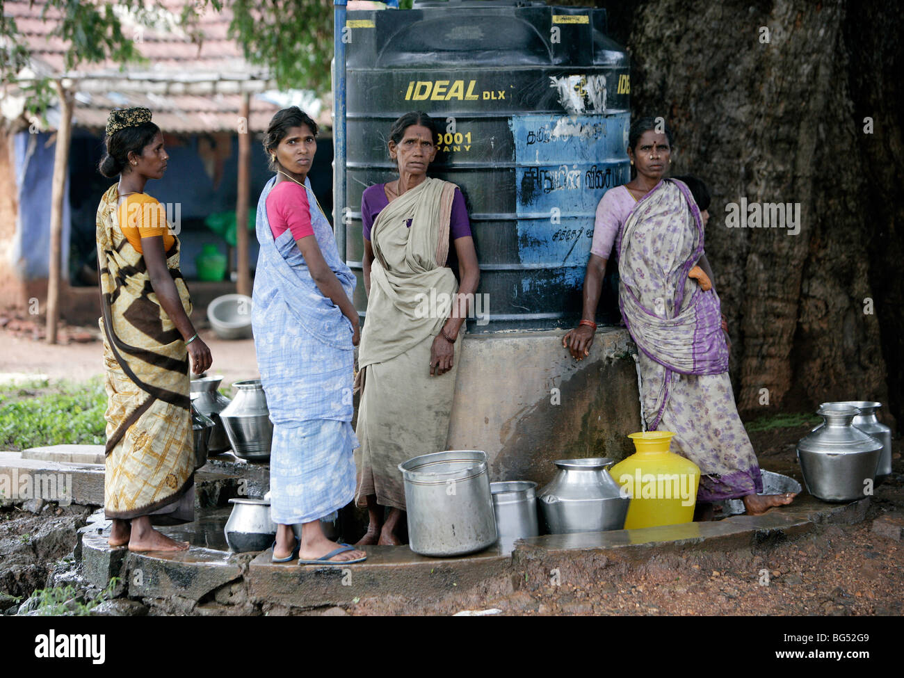 Women fetch water from a freshwater tank in a village in Tamil Nadu ...