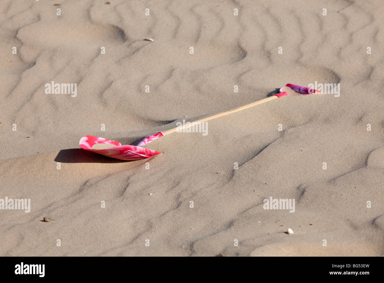 A spade in the sand on a beach in Bournemouth Stock Photo - Alamy