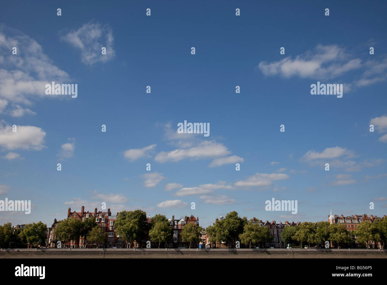 Red brick mansion buildings along Chelsea Embankment. The river Thames ...