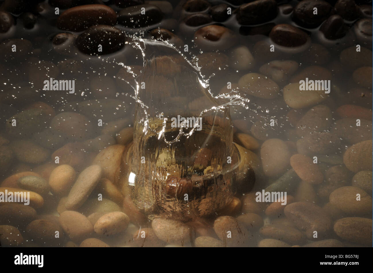A pebble dropping into a shallow stony pool Stock Photo - Alamy