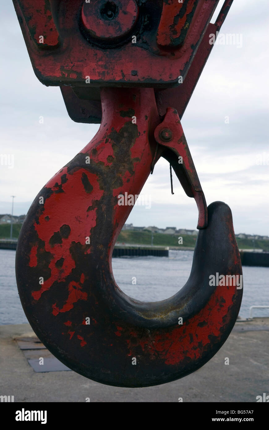 Large hook at the end of a crane, on the quayside at Wick, Caithness ...