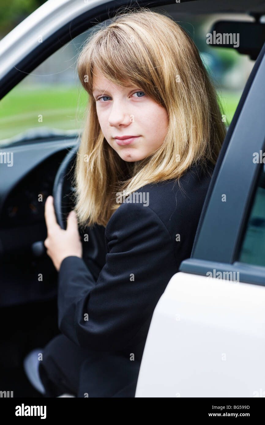 Teenage girl sitting in driver's seat of car Stock Photo - Alamy