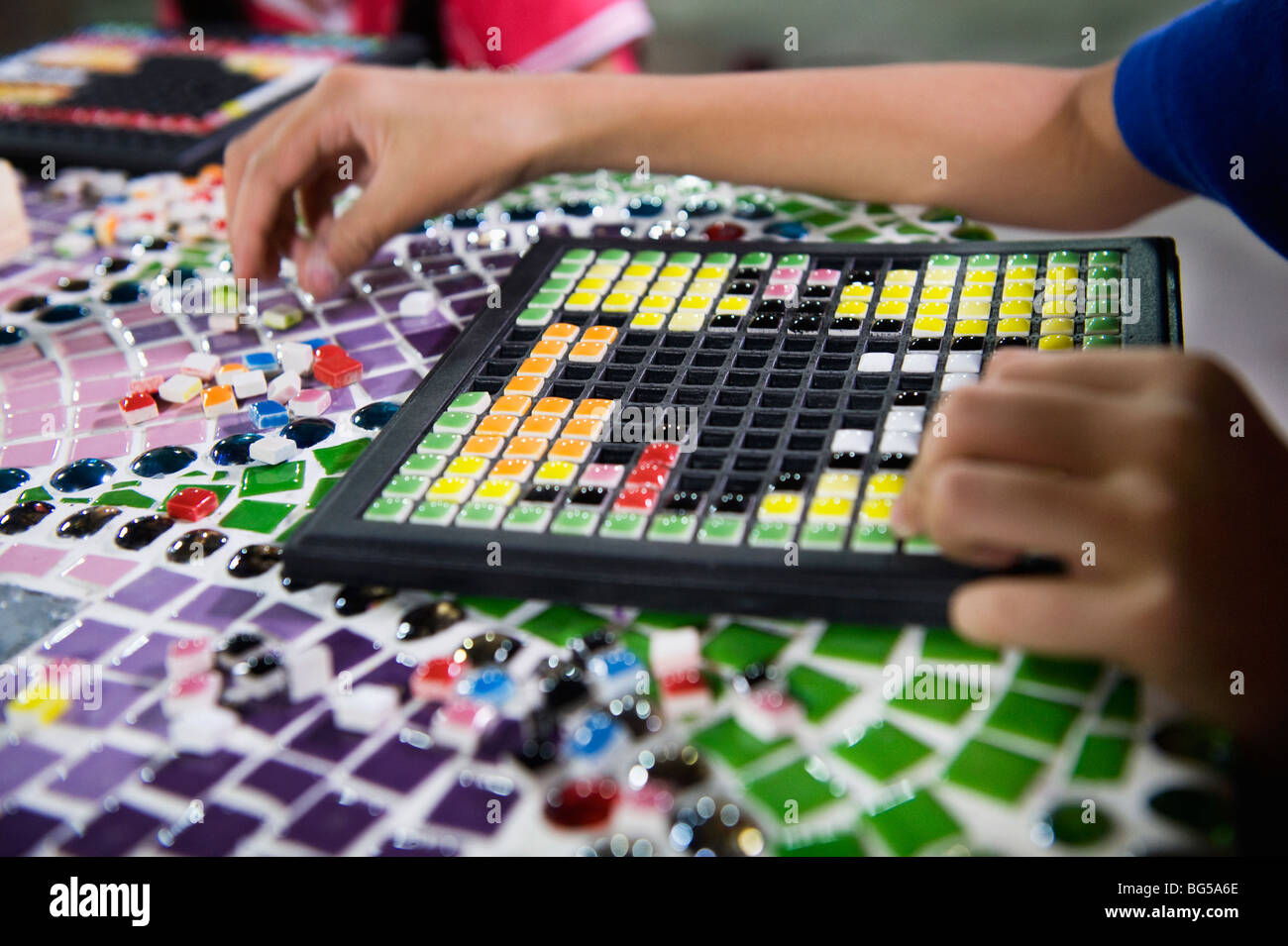A boy creating a mosaic tile Stock Photo - Alamy