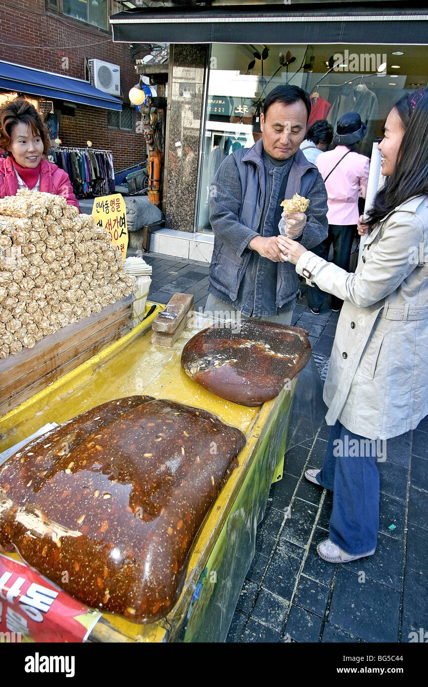 Traditional sweet made by shaving crystalized barley sugar into paper ...