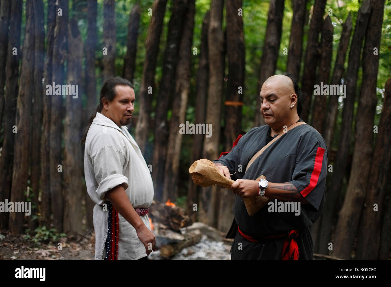 Native American Cherokee Indian hand carving a wooden art in ...