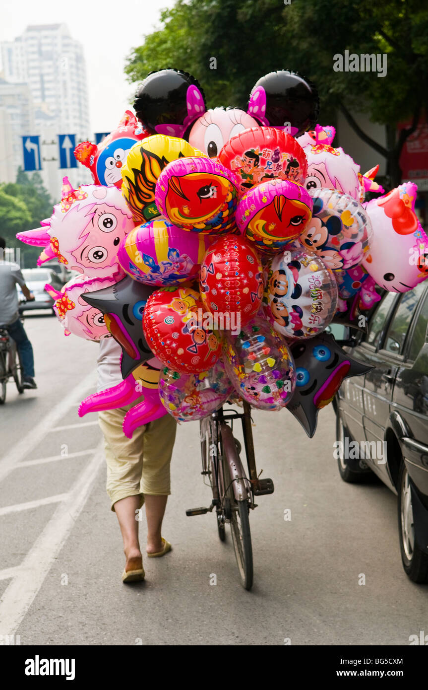 Bicycle full of balloons. a vendor sells his balloons moving around ...