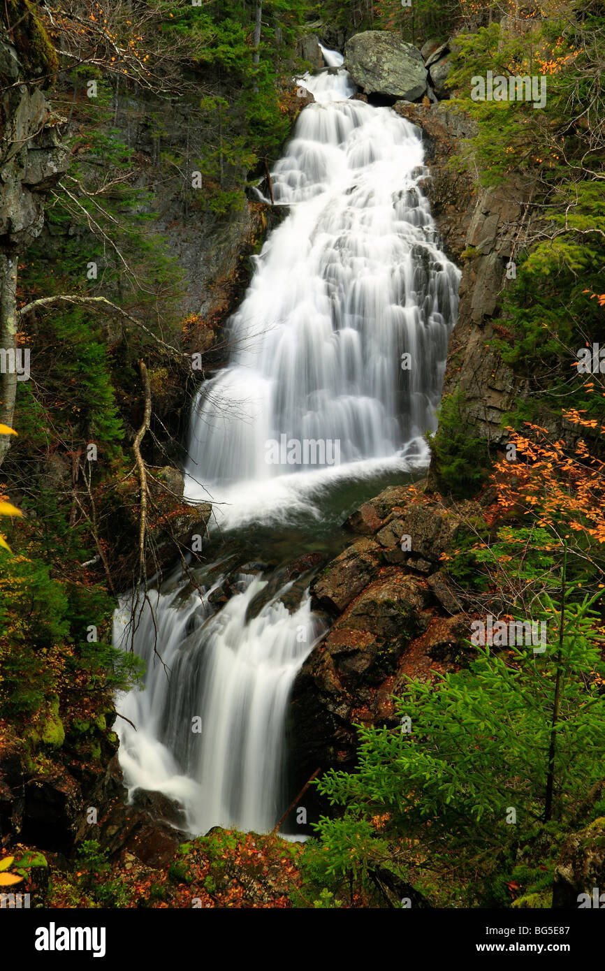 Crystal Cascade waterfall and fall foliage, with water flow running ...
