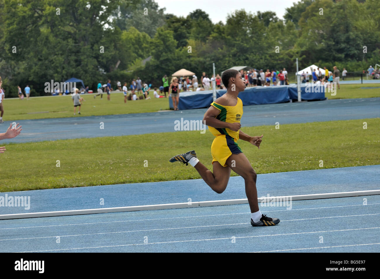 Young boy runner at the Track and Field competition during the ...