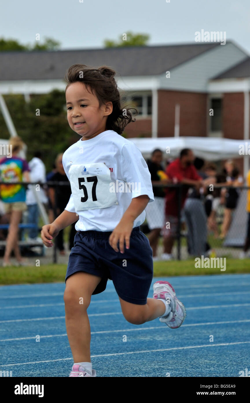 Young girl runner at the Track and Field competition during the ...