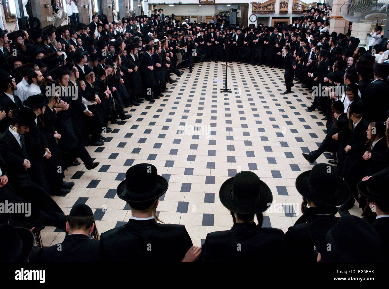 orthodox jews dancing together during the joy of the drawing of sukkot ...