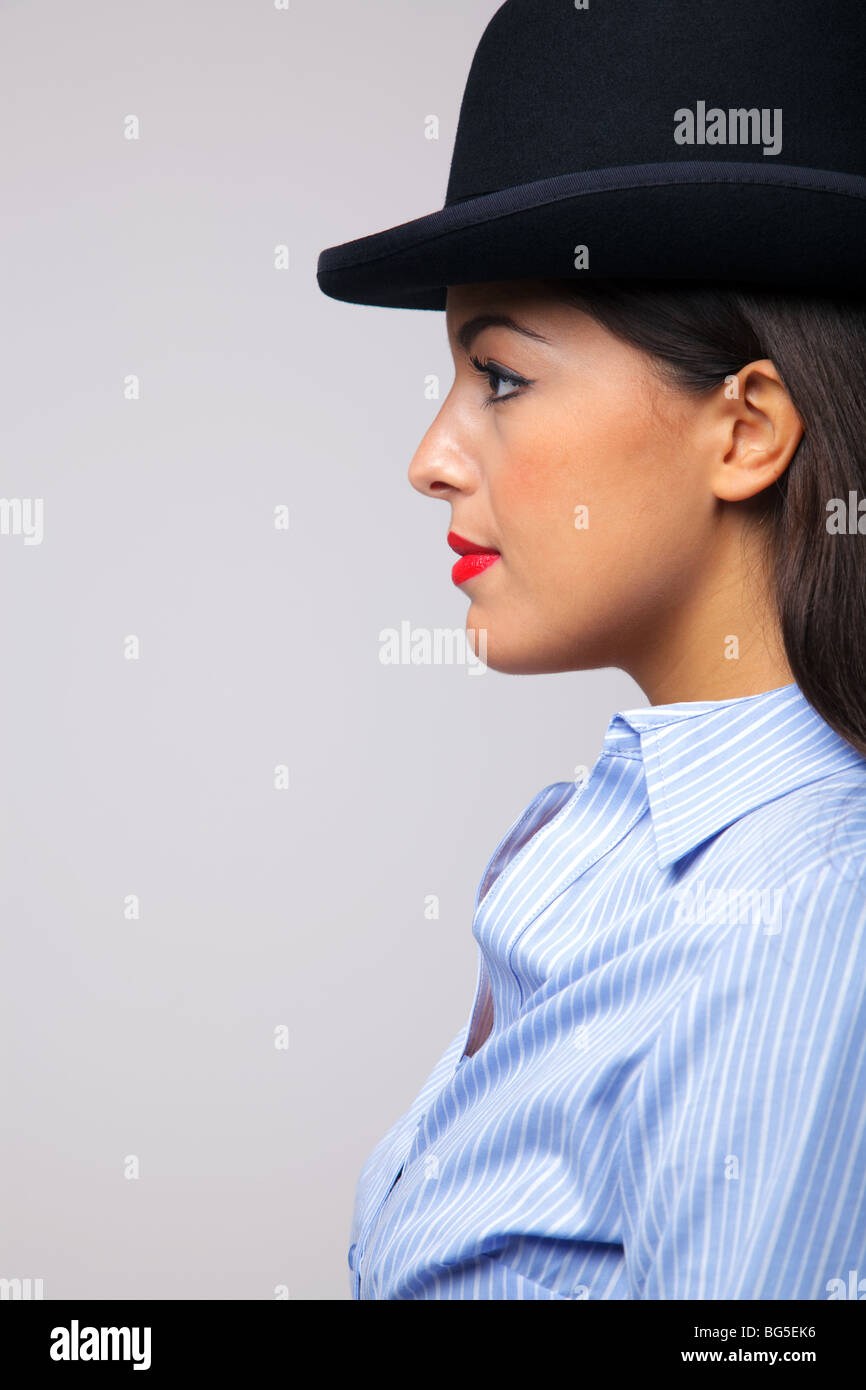 Side view of a businesswoman wearing a bowler hat Stock Photo - Alamy